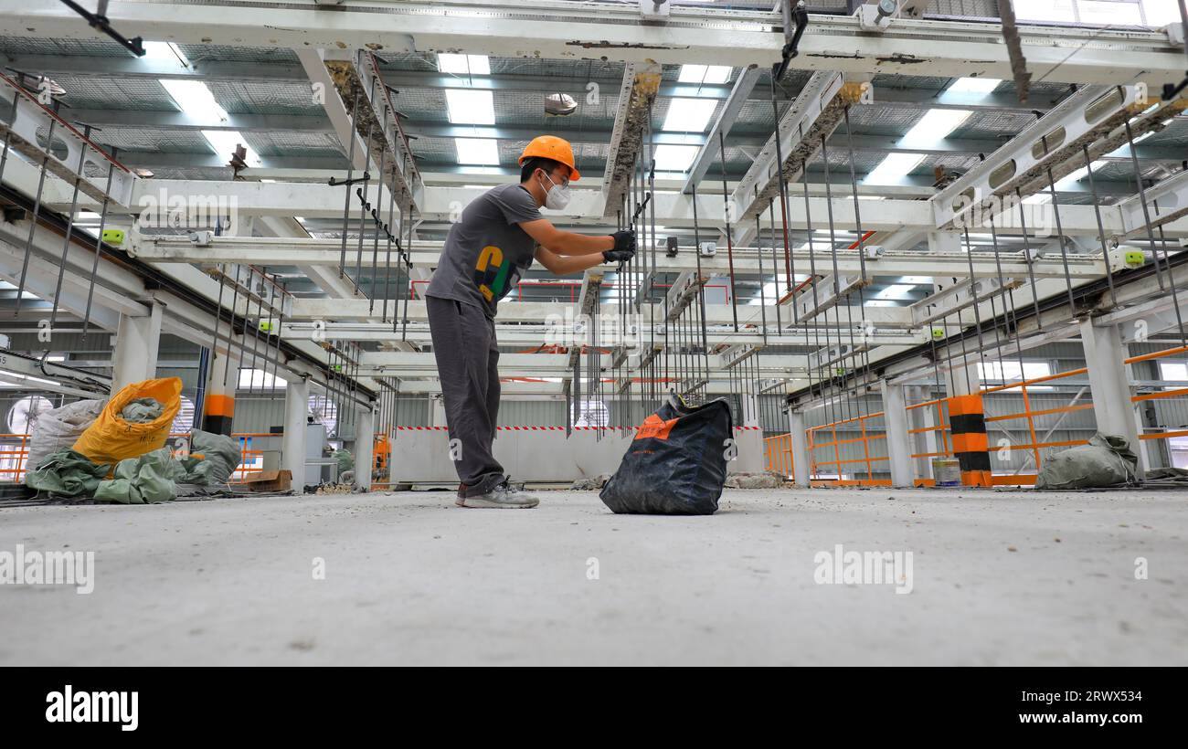 Luannan County, China - June 27, 2023: Workers hang steel mesh on the ...