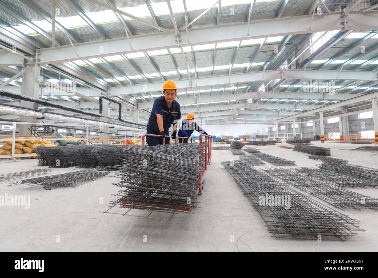 Luannan County, China - June 27, 2023: Workers hang steel mesh on the ...