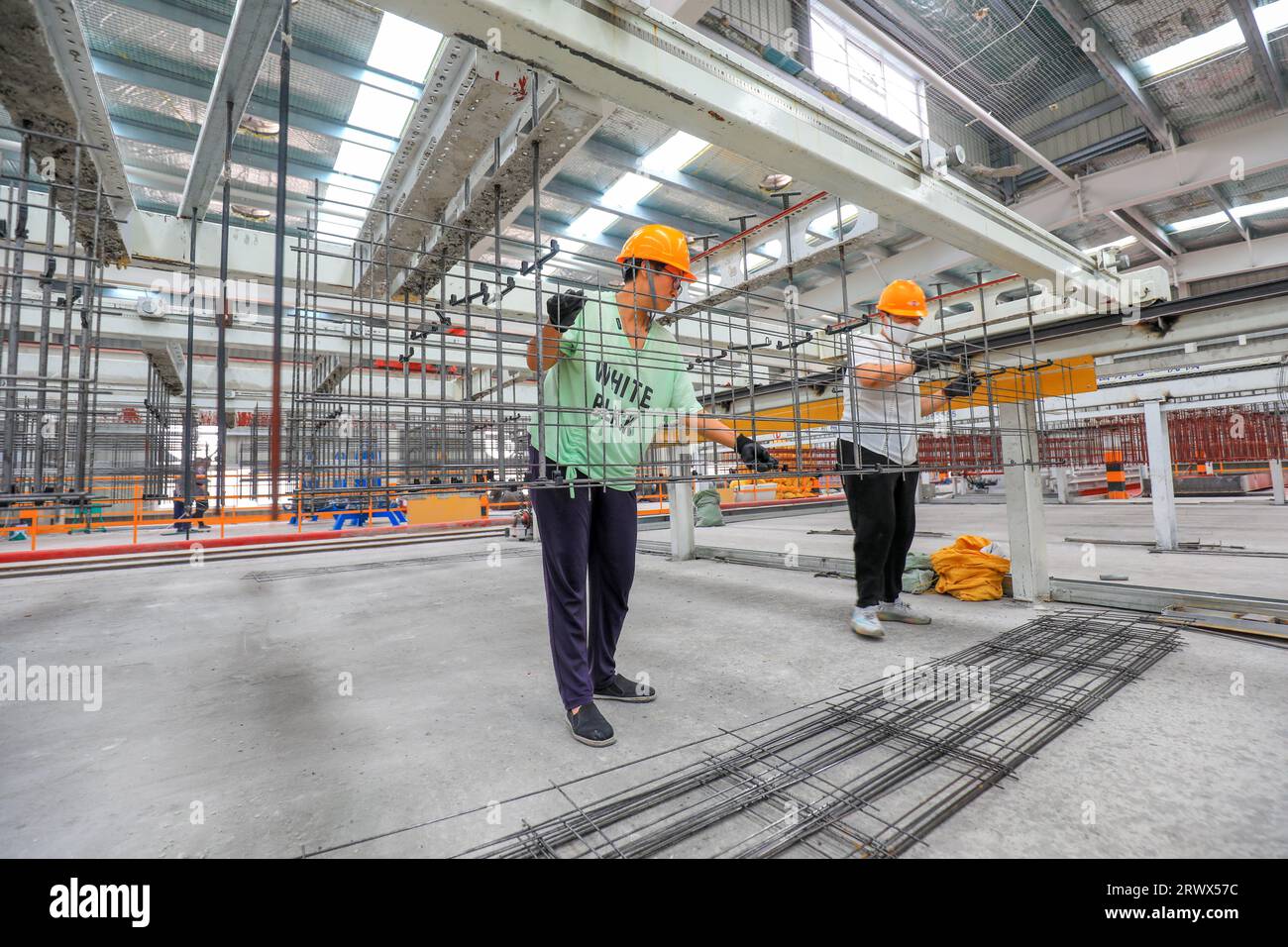 Luannan County, China - June 27, 2023: Workers hang steel mesh on the ...