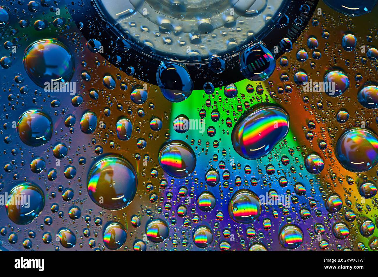 Thick blue and green beam of light behind floating bubbles in abstract ...