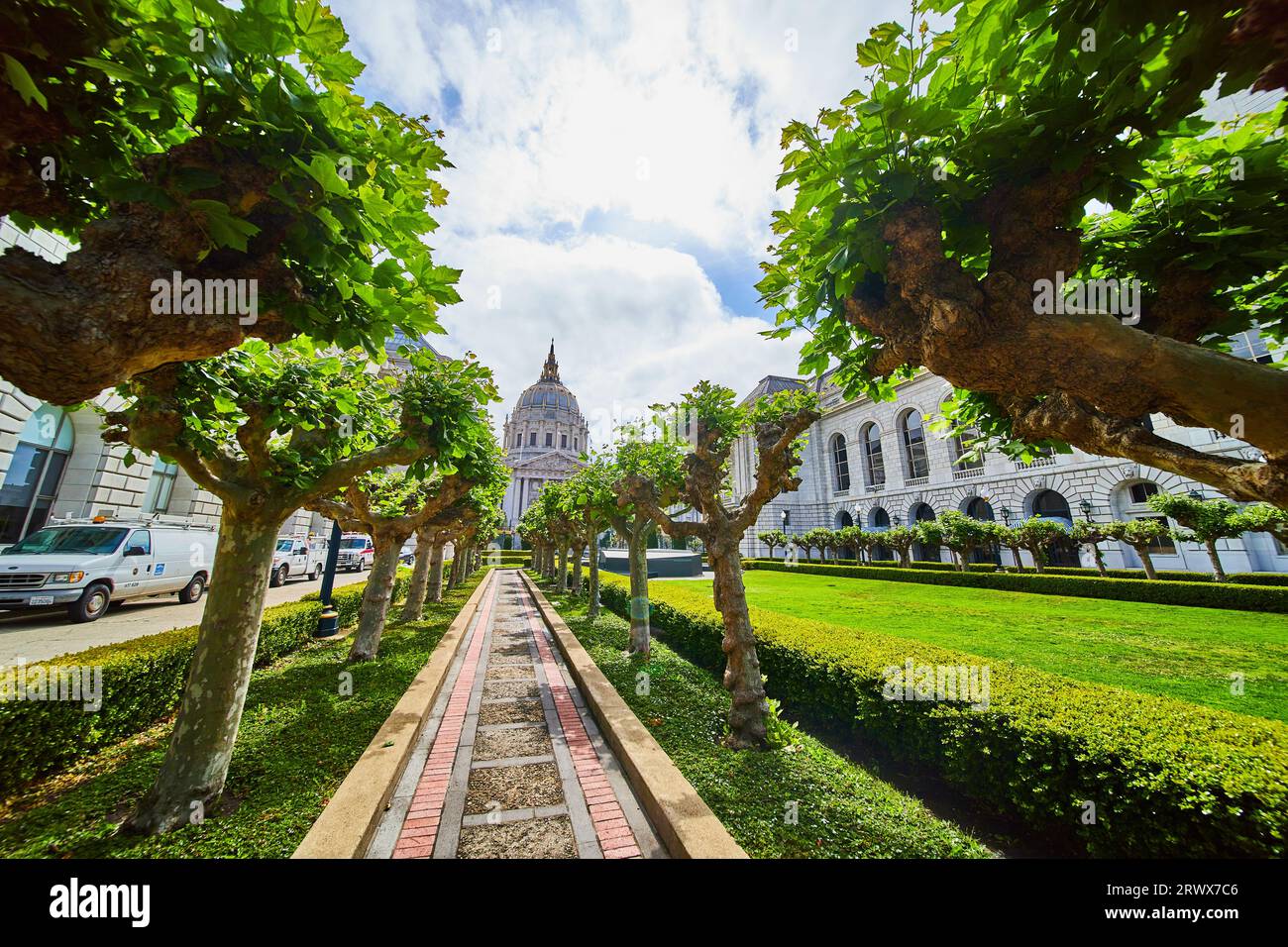 Pathway through Memorial court lined by trees with war memorial in ...