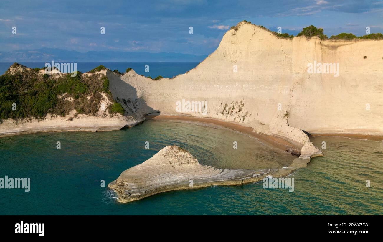 Aerial view of a stunning beach with dramatic cliffs on either side ...