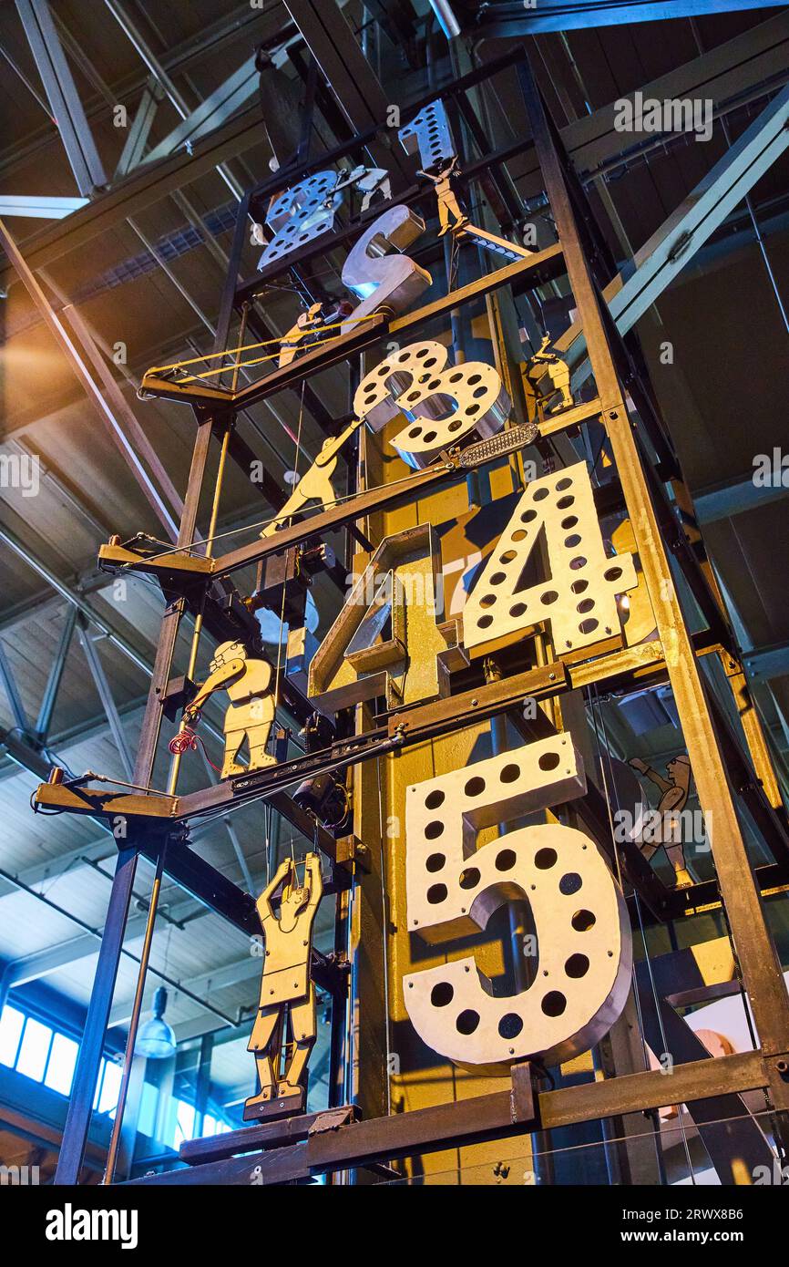 Tall clock tower with mechanical people moving numbers one through five ...