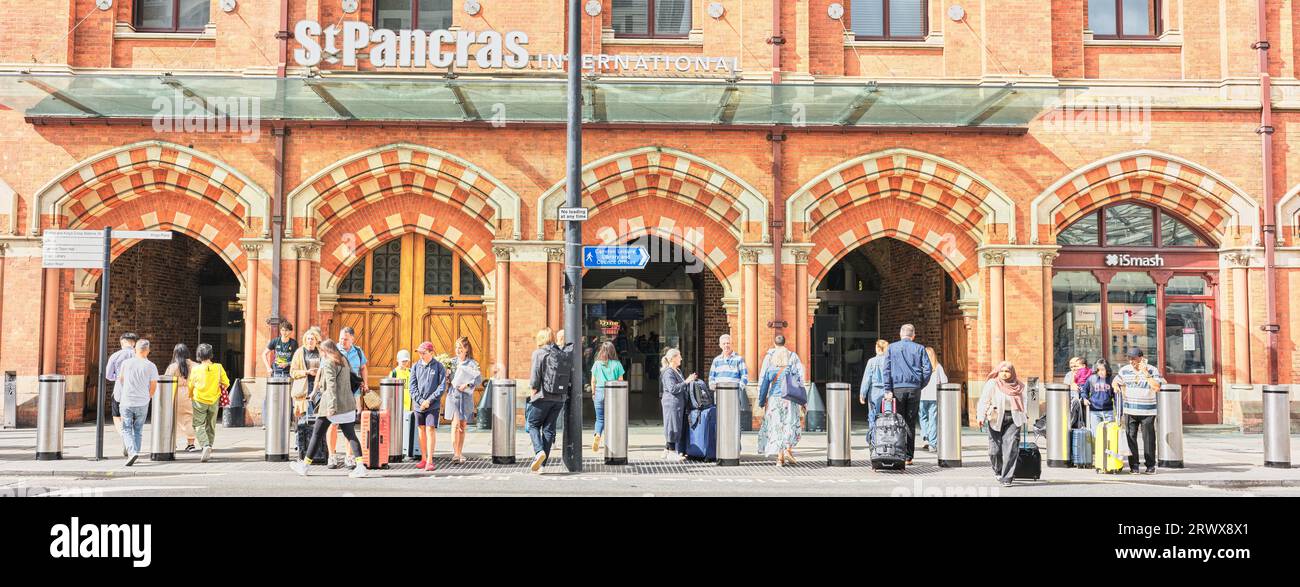 Rail travellers outside the arched entrance to the victorian brick ...