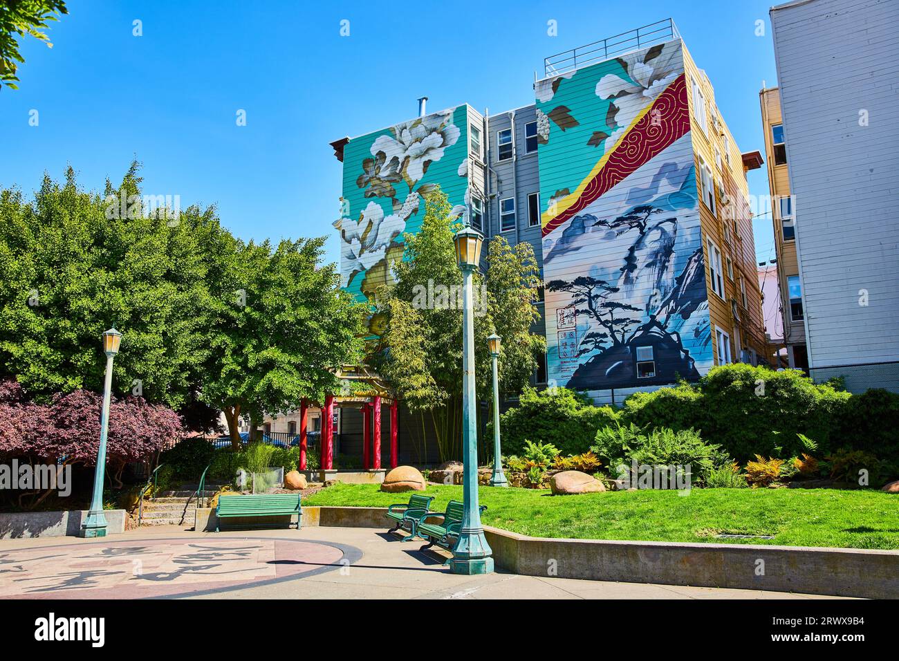 Peaceful and zen art mural on buildings overlooking sunny park with red ...