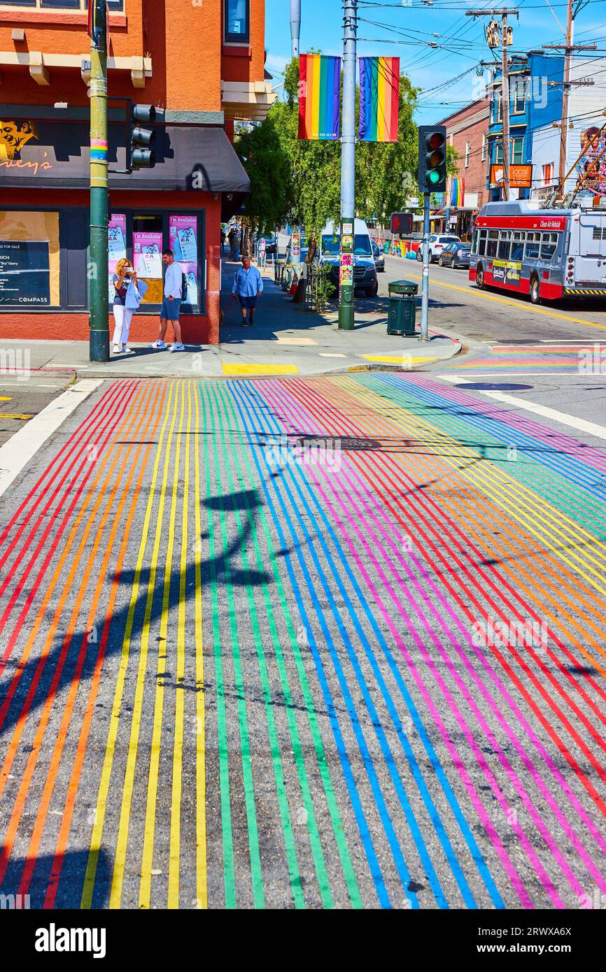Telephone pole shadow falling across rainbow crosswalk with LGBTQ+ ...