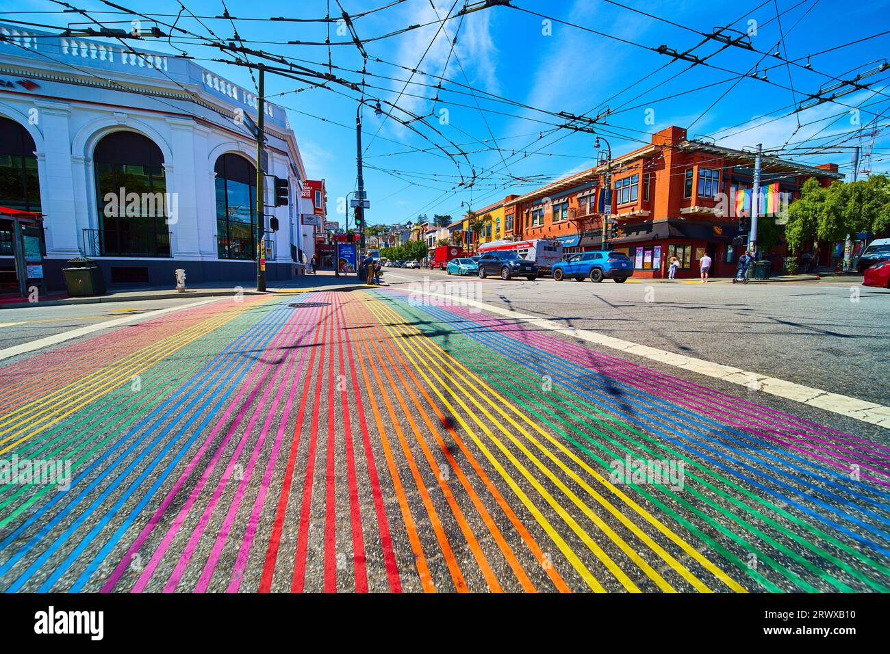 Castro District rainbow crosswalk with store fronts and brilliant blue ...