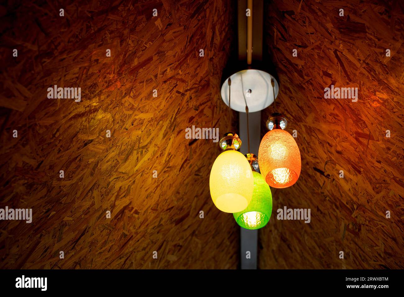 Hanging color lampshades on dark background. Composition of multi ...