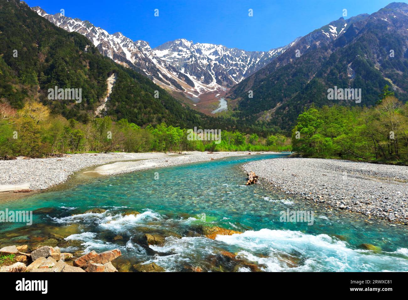 Lingering snow on the clear stream of Azusa River and the Hotaka ...