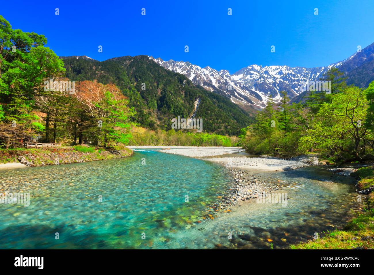 Lingering snow on the clear stream of Azusa River and the Hotaka ...