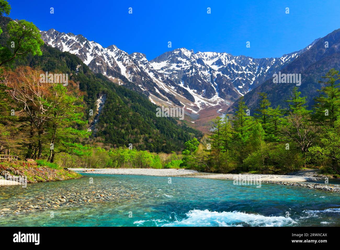 Lingering snow on the clear stream of Azusa River and the Hotaka ...