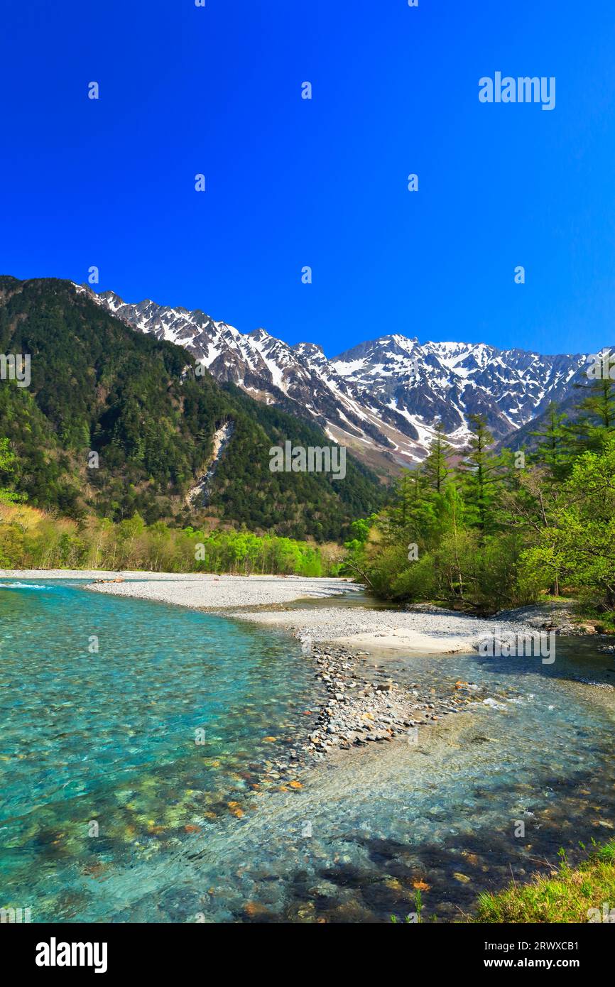 Lingering snow on the clear stream of Azusa River and the Hotaka ...