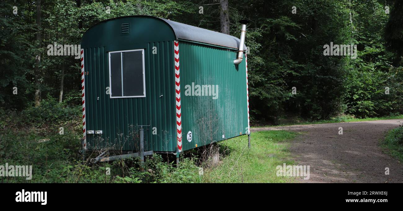 a green trailer in the forest Stock Photo - Alamy