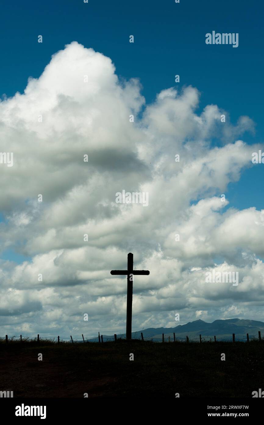 Wooden cross under a cloudy sky. Cezallier plateau. Puy de Dome ...