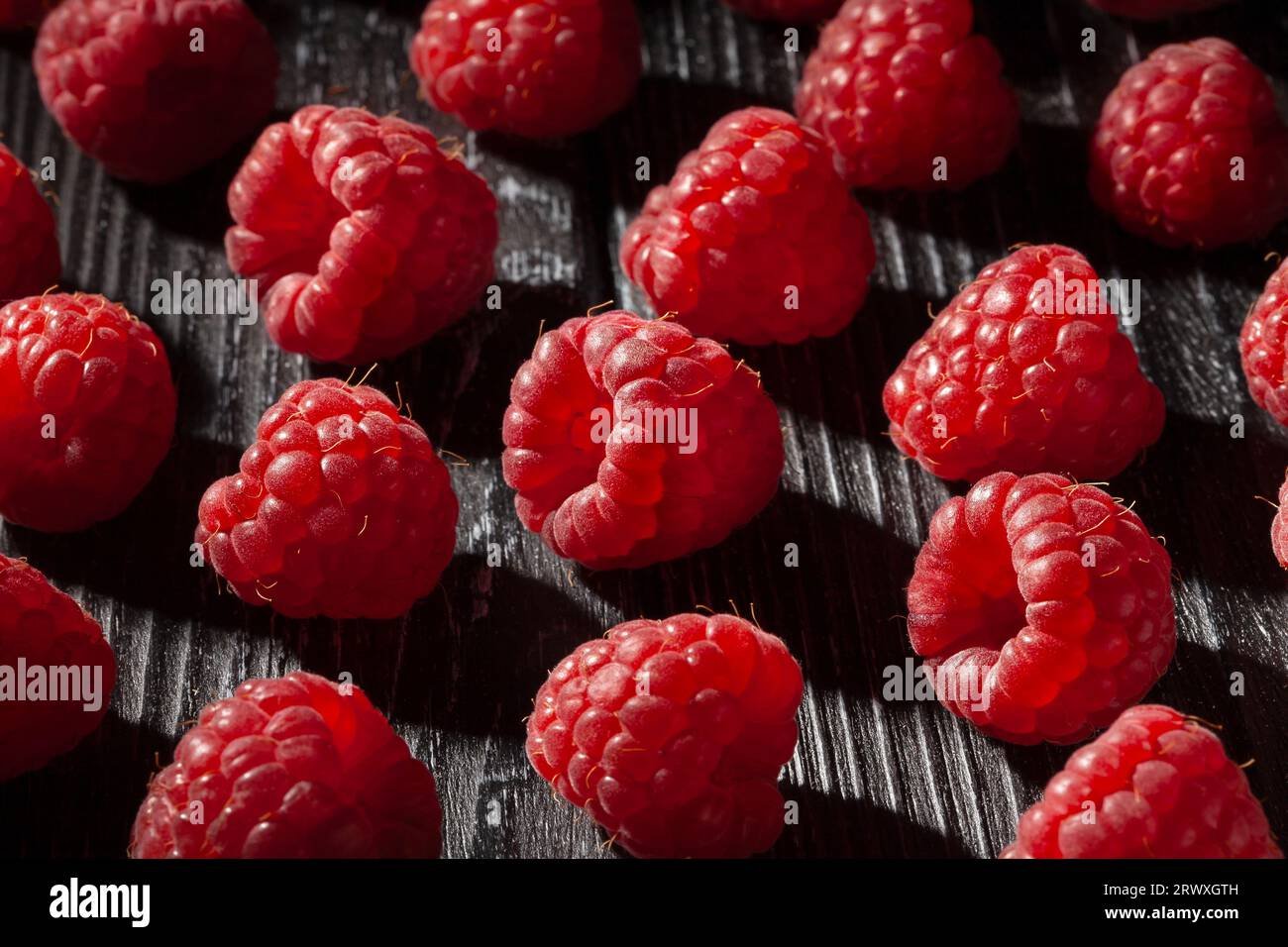 raspberry group on wood background Stock Photo - Alamy