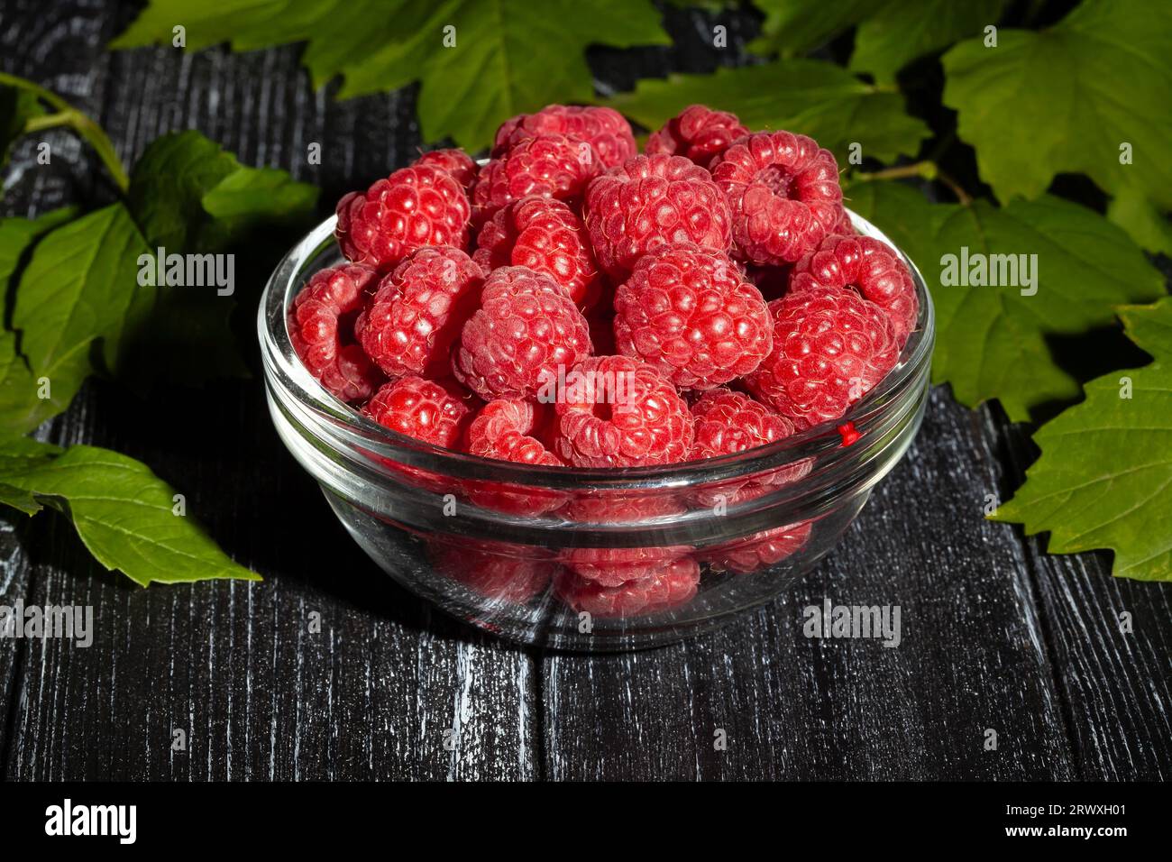 raspberry bowl on wood background Stock Photo - Alamy