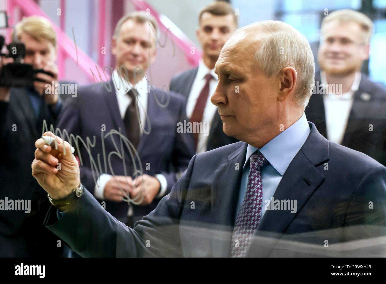 Russian President Vladimir Putin leaves an autograph after attending a ...