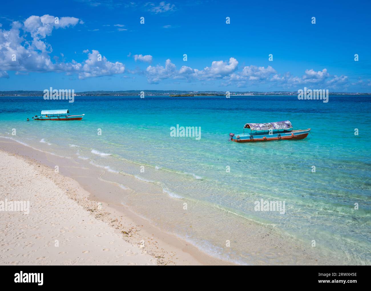 Boats floating parked by a sand bank in Zanzibar, Tanzania Stock Photo ...