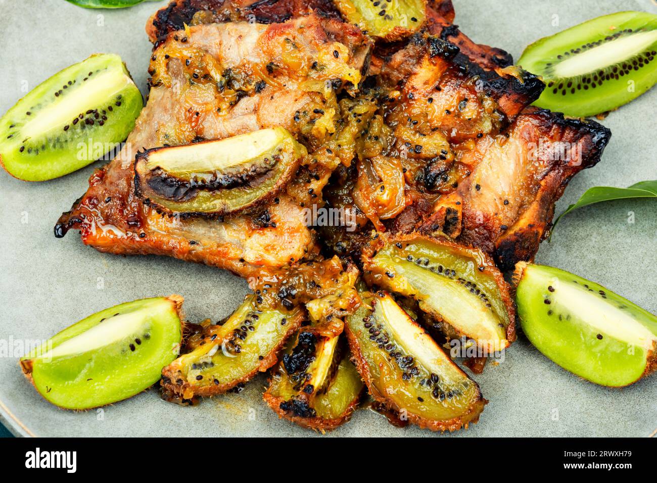 Pork ribs roasted with kiwi. Barbecue meat Stock Photo - Alamy