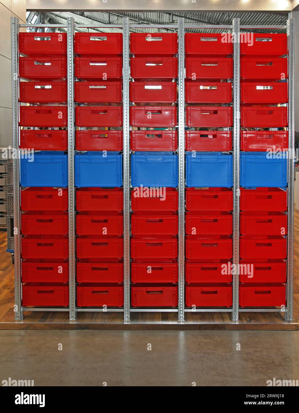 Large Storage Tower Shelf With Red Plastic Crates in Warehouse Stock ...