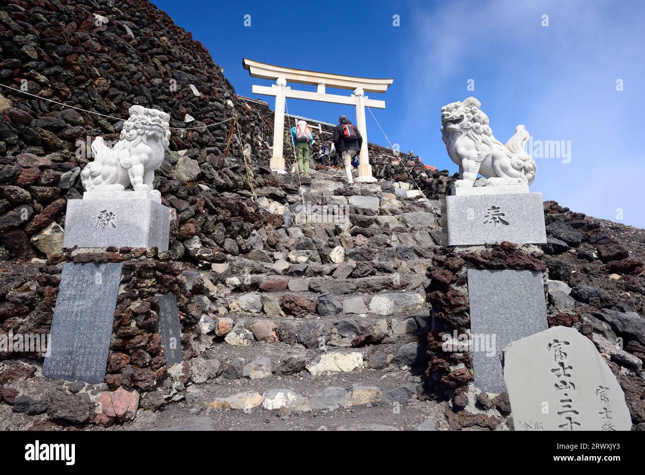 Torii gate and stone statues at the top of Yoshida Route on Mt. Fuji ...