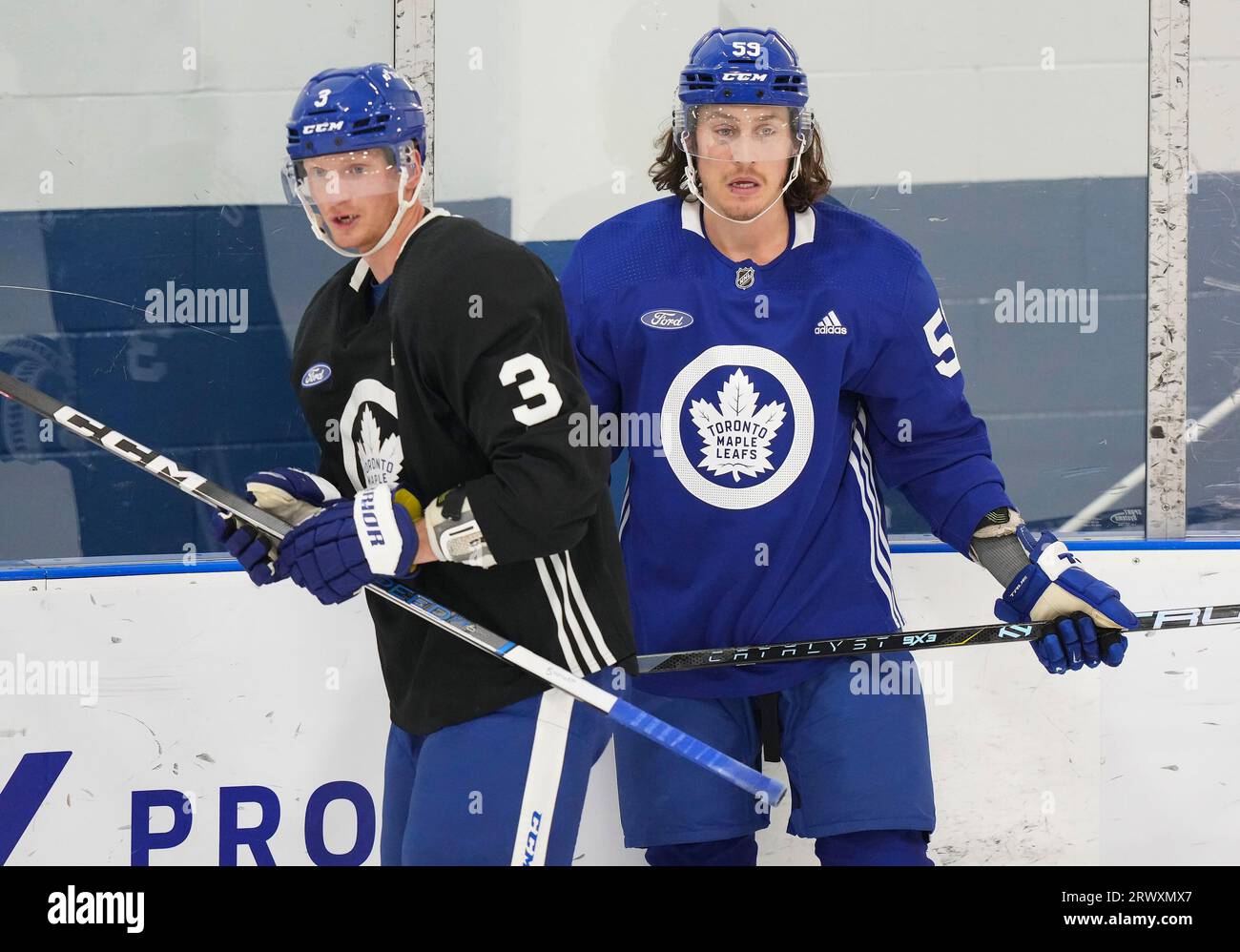 Toronto Maple Leafs defenseman John Klingberg, left, looks up ice with ...