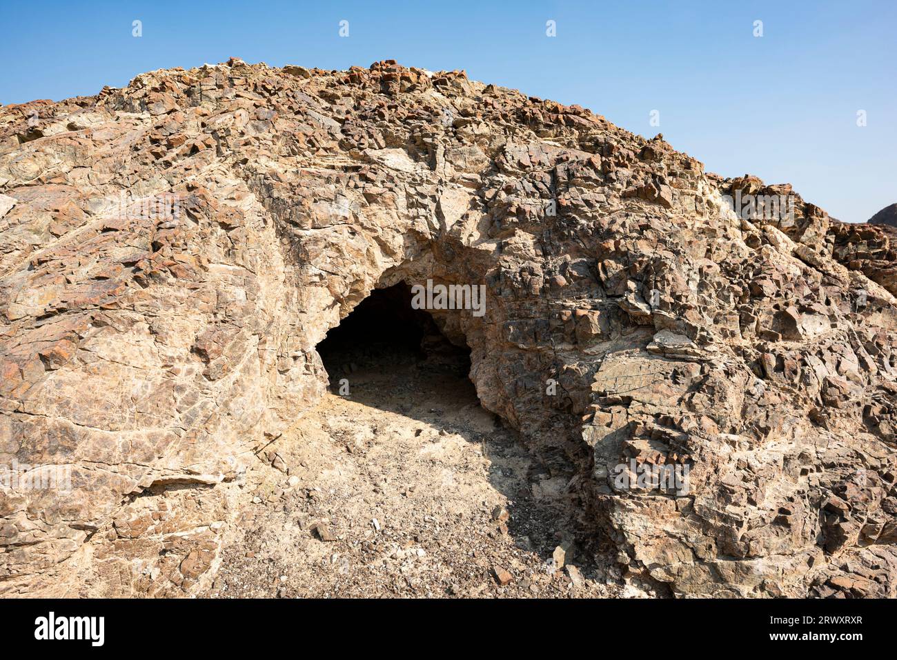 A small cave nestled in the Hajar Mountains, providing a possible ...