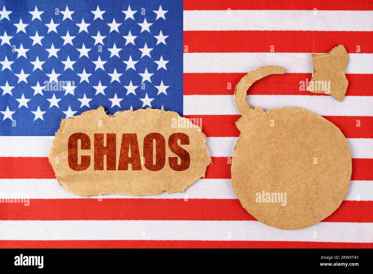 On the flag of the United States are a bomb cut out of cardboard and a ...
