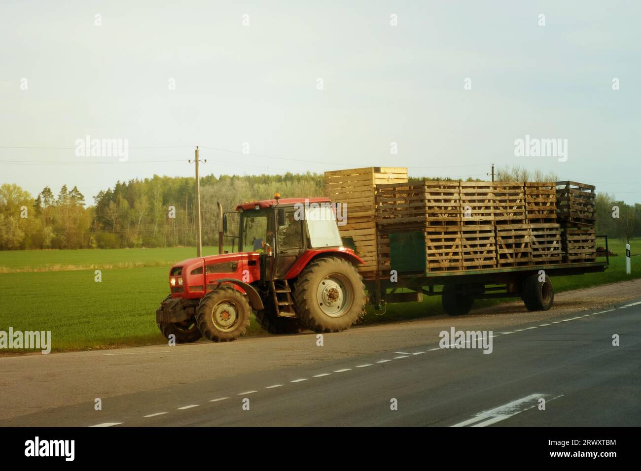 A tractor transports wooden containers in a trailer Stock Photo - Alamy