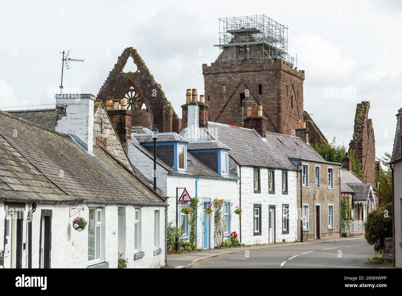 The village of New Abbey with Sweetheart Abbey towering above the small ...