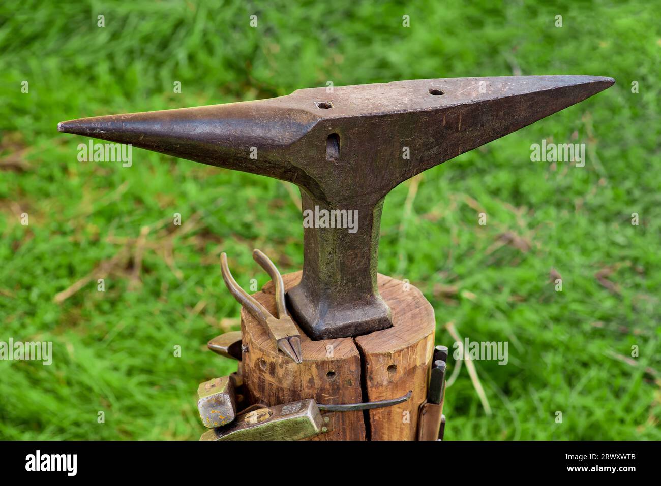 The metal anvil and other tools for blacksmithing on a background of ...