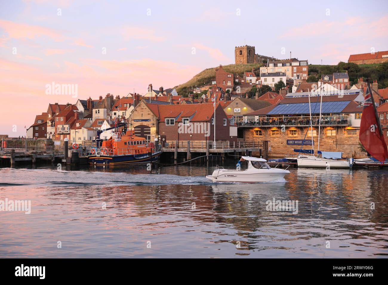 Sunset over pretty Whitby harbour on the North Yorkshire coast, UK ...