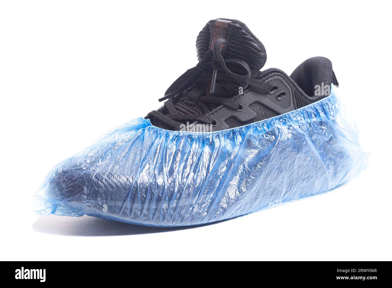 men's black sneakers in shoe covers isolated on white background Stock ...