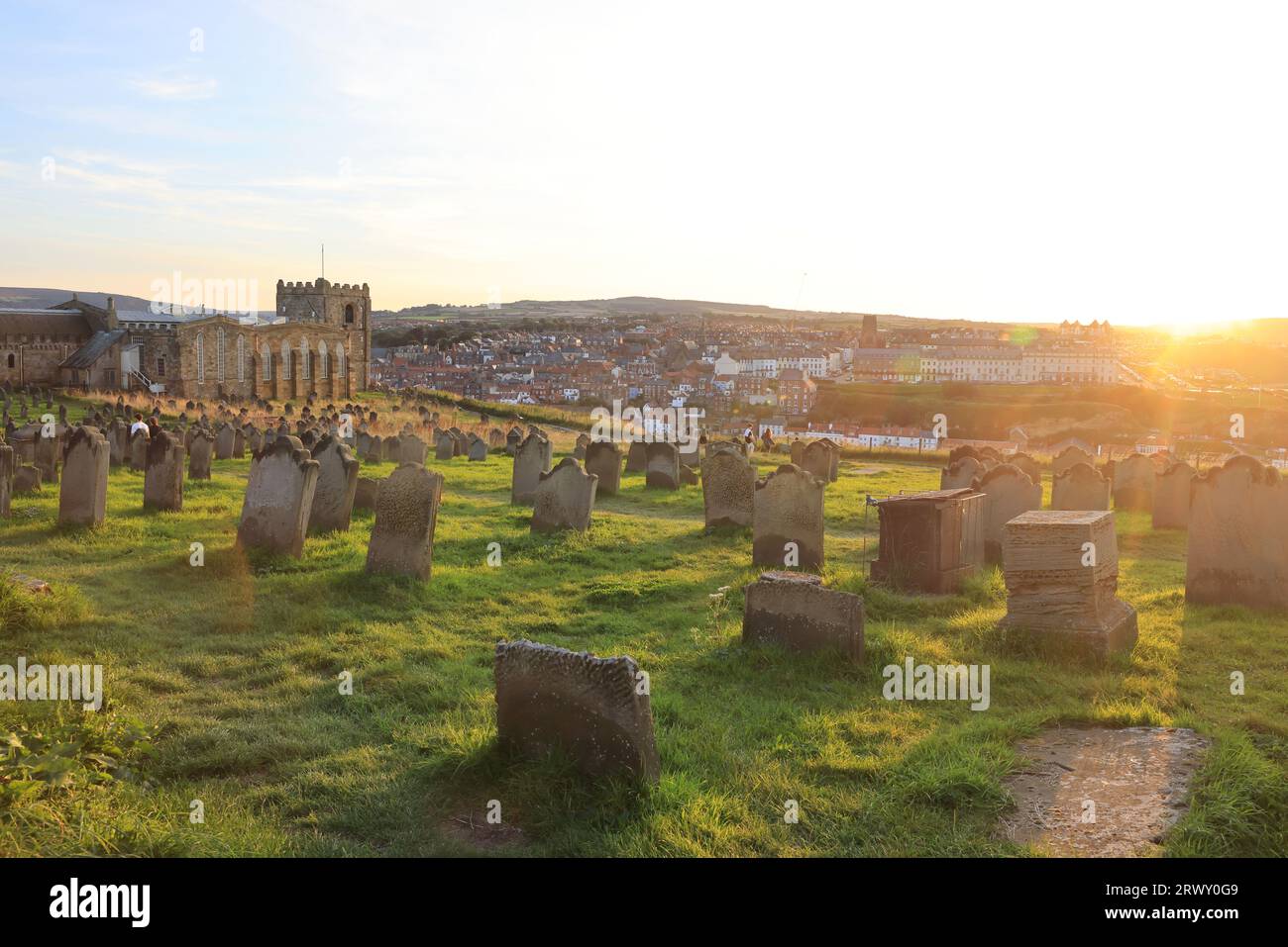 Sunset over the graveyard of historic St Mary's Church on windswept ...