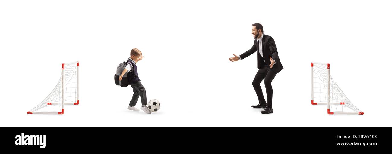 Schoolboy and businessman playing football in front of mini goals ...
