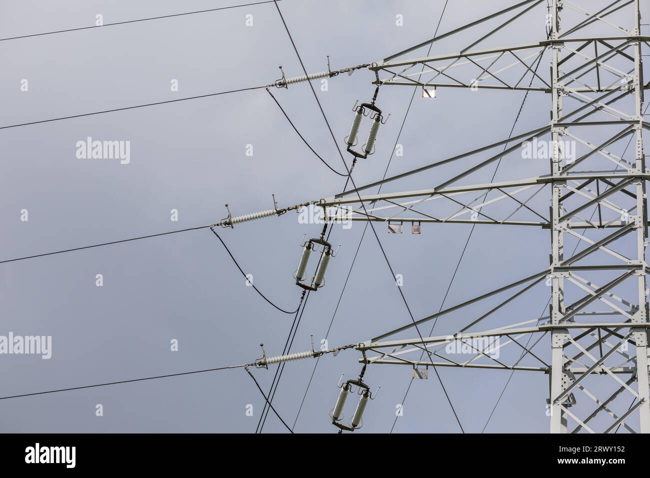 View of electrical insulators on a high-voltage overhead line pole ...