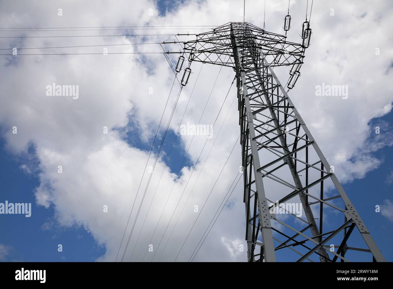 View from below of the tall poles of the high-voltage overhead line ...