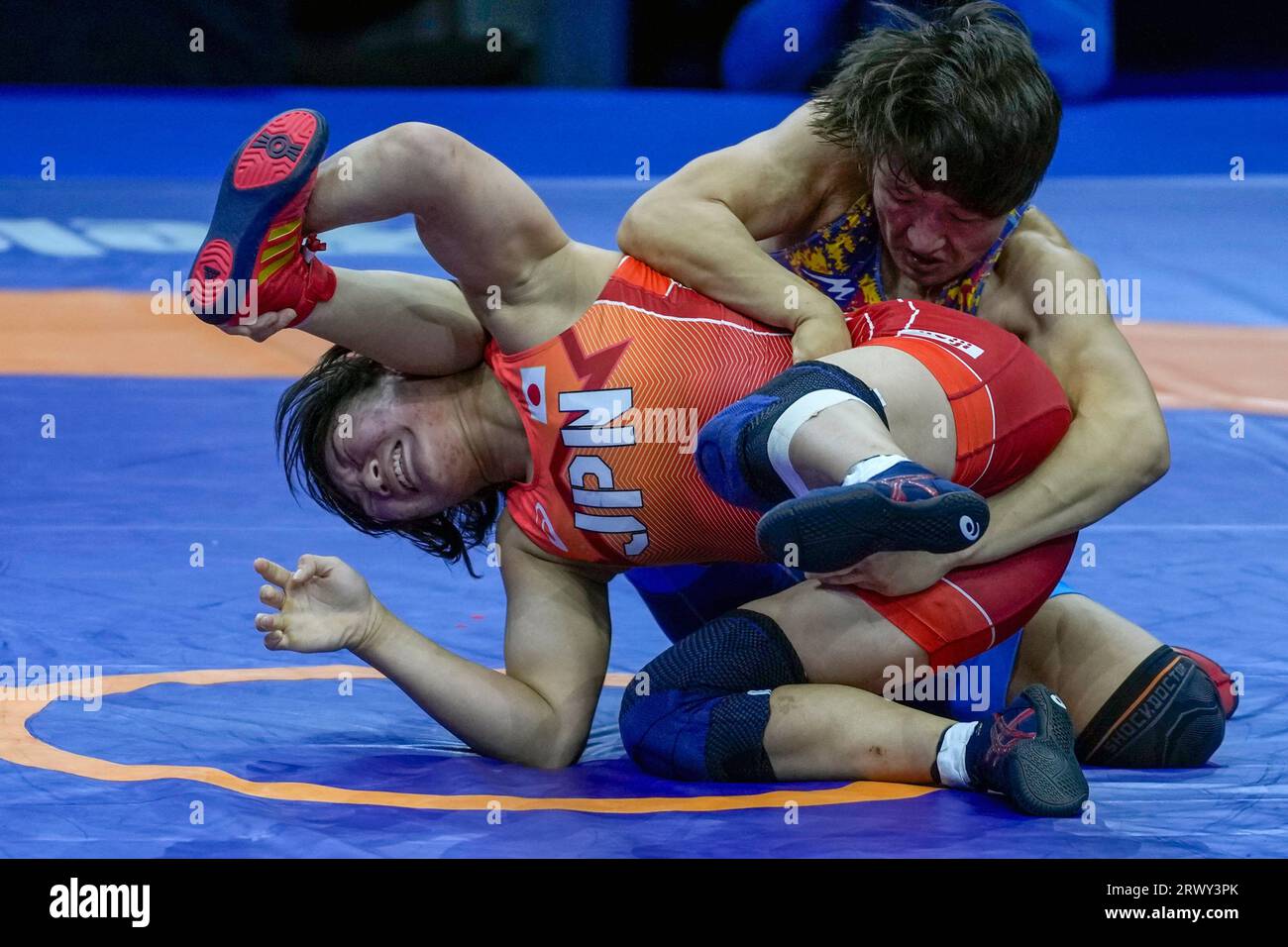 Kyrgyz Aisuluu Tynybekova, blue, and Sakura Motoki of Japan compete in ...