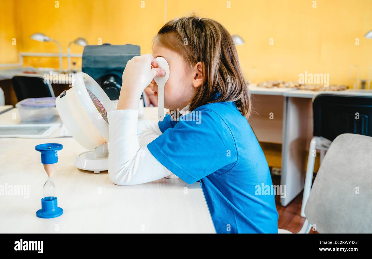 Little girl in medical office undergoing advanced laser vision ...