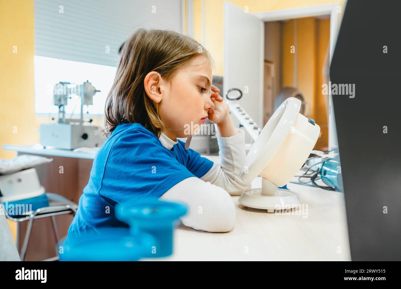 Little girl in medical office undergoing advanced laser vision ...