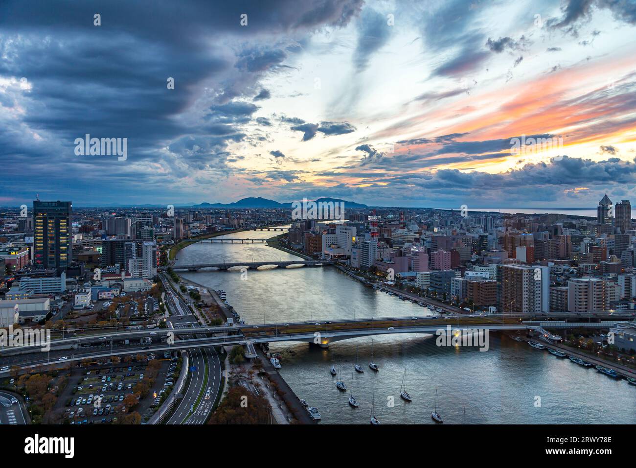 Beautiful sunset and the cityscape along the Niigata Shinano River ...