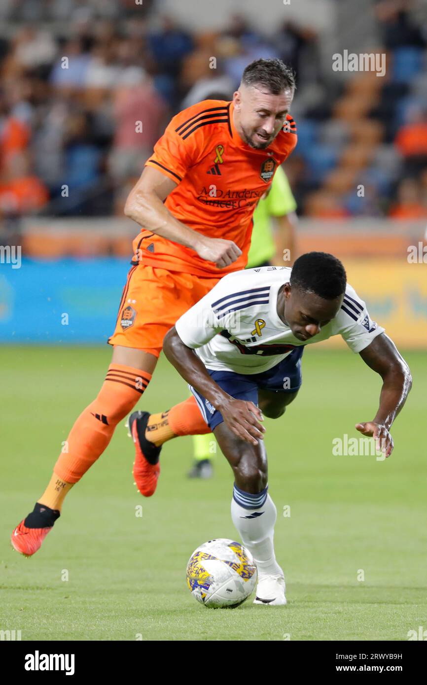 Houston Dynamo midfielder Hector Herrera, left, knocks over Vancouver ...