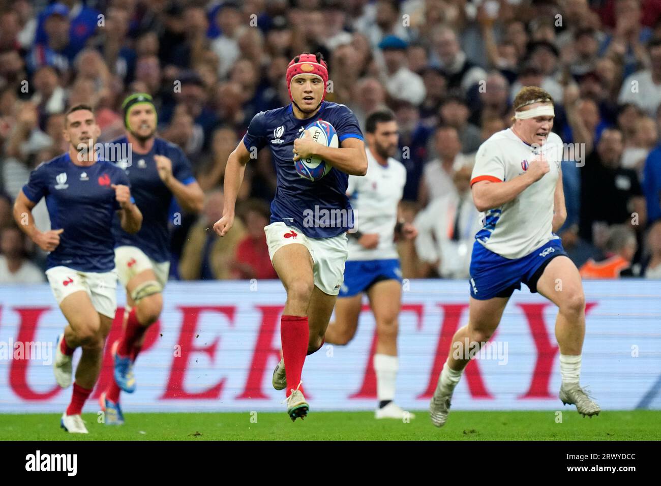France's Louis Bielle-Biarrey runs with the ball before scoring a try ...