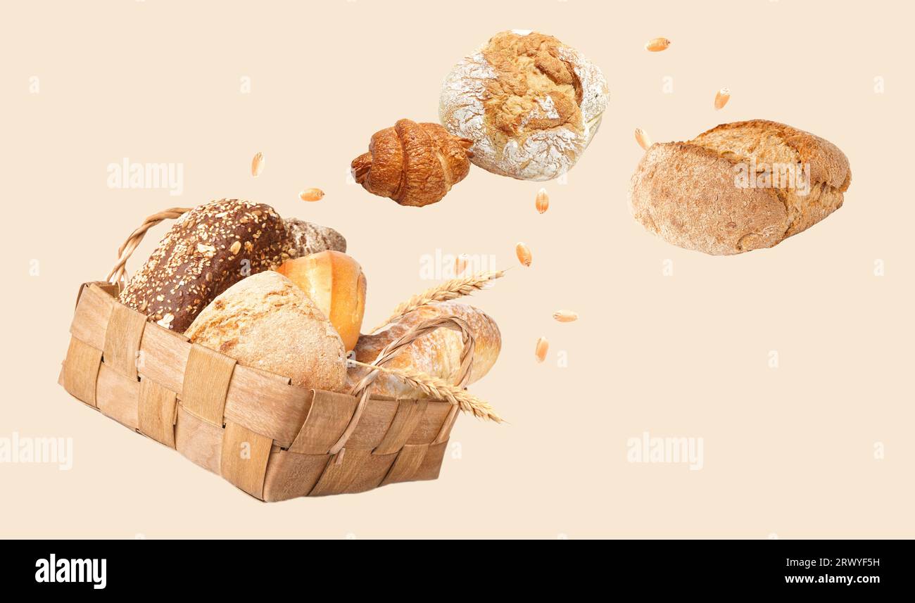 Flying basket with different bakery products on beige background Stock ...