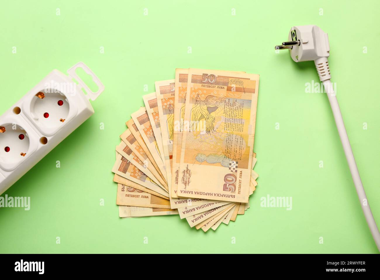 Bulgarian lev banknotes with plug and power socket on green background ...