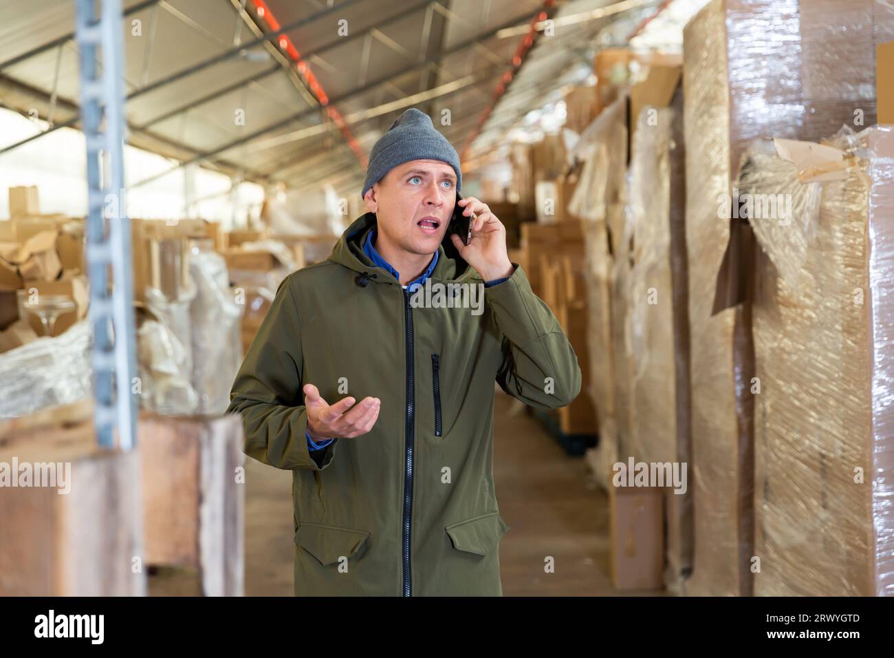 Storekeeper having telephone conversation during working day Stock ...