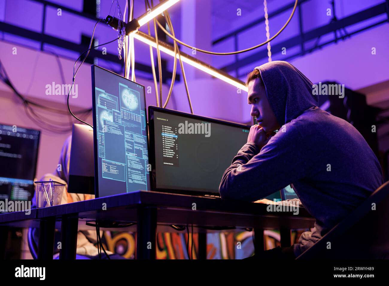 Asian hacker breaking into company database and stealing confidential information. Man cracking ...