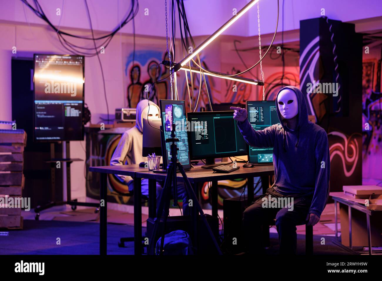 Anonymous scammer live streaming threat on mobile phone while breaking ...