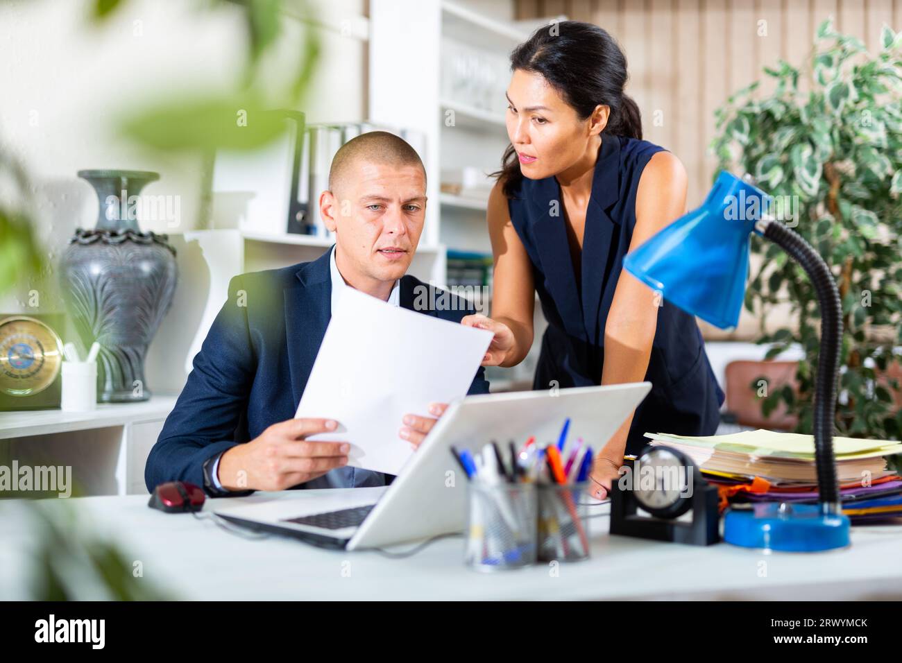 Business people working with papers together Stock Photo - Alamy