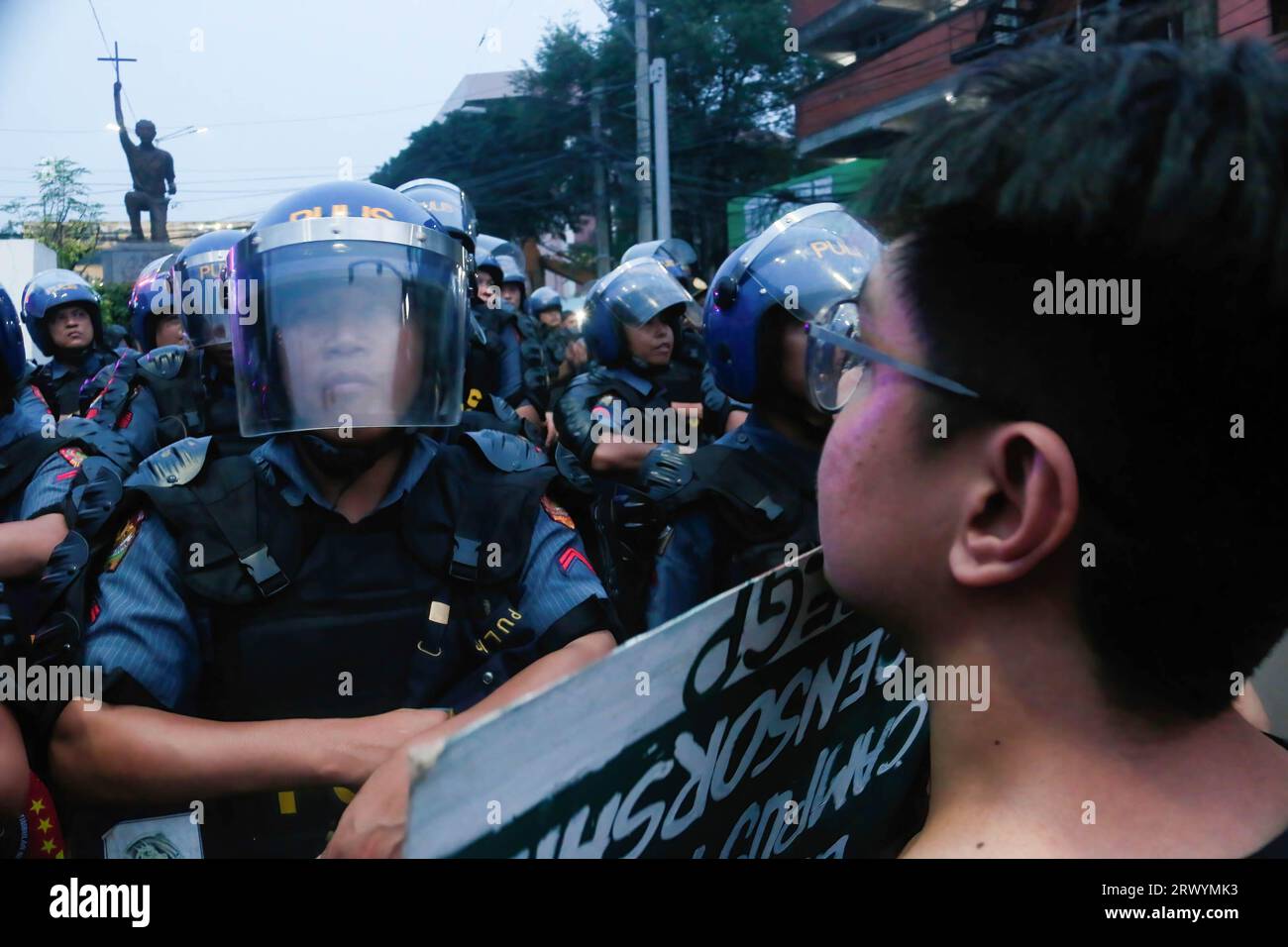 Protester Faces A Line Of Police Officers During The Demonstration